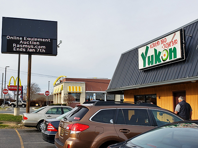 The unassuming exterior of Yukon Korean BBQ & Sushi Bar proves once again that culinary treasures often hide in plain sight along Dover's commercial strips.