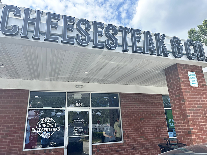 The unassuming storefront speaks volumes: "100% RIB-EYE CHEESESTEAKS" isn't just a promise&mdash;it's a delicious declaration of intent.