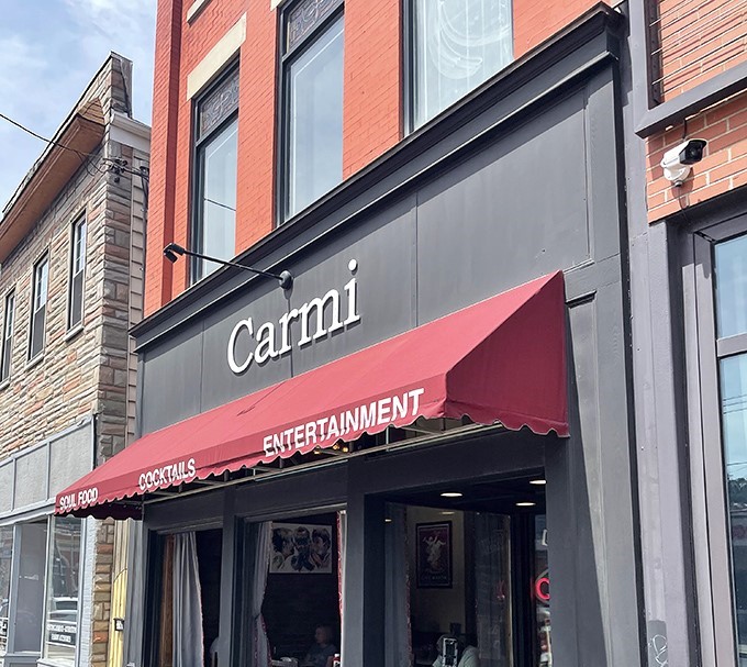 The iconic red brick exterior of Carmi Soul Food stands like a beacon of Southern comfort in Pittsburgh's urban landscape. Soul food salvation awaits inside.