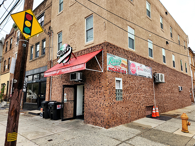 The corner brick building with its iconic red awning stands like a sandwich sentinel, guarding Philadelphia's hoagie heritage for generations.