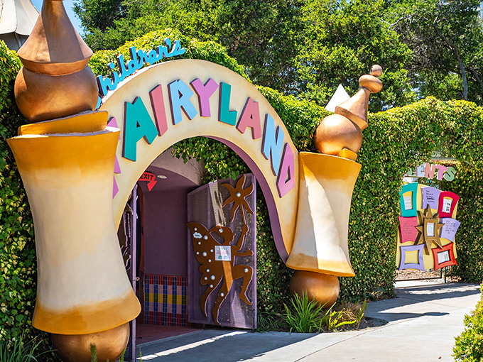 The Old Woman's Shoe House stands like a golden beacon of childhood wonder, complete with teal roof and whimsical charm that defies architectural logic.