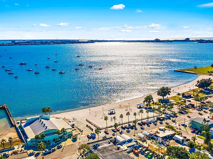 Boca Ciega Bay sparkles like nature's own disco ball, offering a waterfront playground where boats bob peacefully and palm trees stand sentinel along the shore.