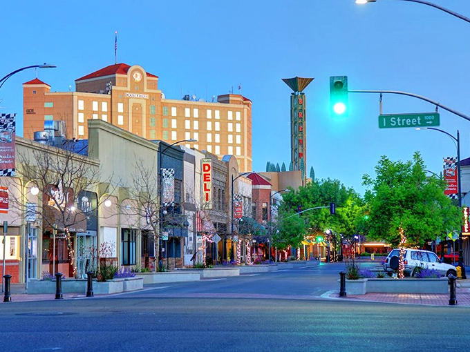 Downtown Modesto at dusk transforms into a postcard-perfect scene, where the historic architecture meets modern charm under the glow of street lamps.