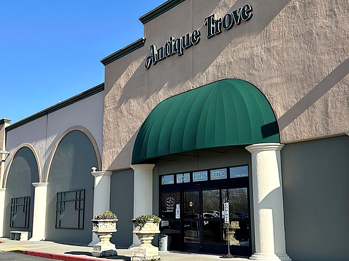 The stately facade of Antique Trove beckons with its elegant columns and distinctive green awning&mdash;architectural foreplay for the treasure hunt that awaits inside.
