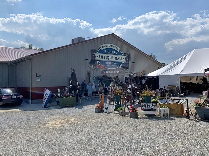 The unassuming exterior hides a wonderland of treasures inside, like finding out your quiet neighbor was once a rock star. Treasure hunters gather at the entrance, already eyeing potential finds.