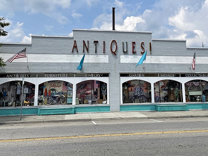 The white facade with its bold "ANTIQUES!" sign is like a siren call to treasure hunters. This isn't just shopping&mdash;it's time travel with a parking lot.