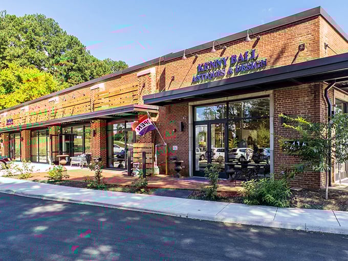 The brick façade of Kenny Ball Antiques beckons like a time portal disguised as a charming storefront. History awaits inside!