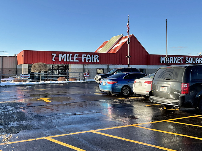 The iconic red-roofed entrance to 7 Mile Fair stands like a beacon for bargain hunters, promising treasures waiting to be discovered inside.