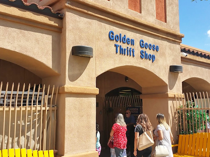 The stucco facade of Golden Goose Thrift Shop beckons like a desert mirage, promising treasures within its Spanish-style walls.