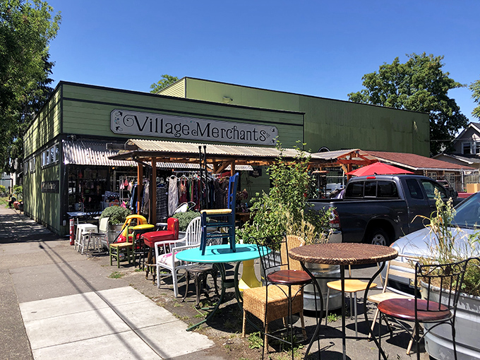 The unmistakable green facade of Village Merchants stands like a beacon of secondhand treasures on SE Division Street, with colorful outdoor displays beckoning passersby to explore.
