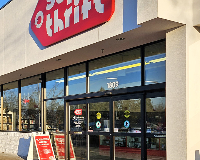 The iconic red SuperThrift sign beckons treasure hunters like a retail lighthouse, promising adventures in secondhand splendor just beyond those glass doors.