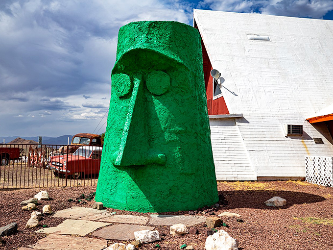 The stoic green guardian of Route 66 stands watch, its expression unchanging yet somehow judging your life choices with silent Tiki wisdom.
