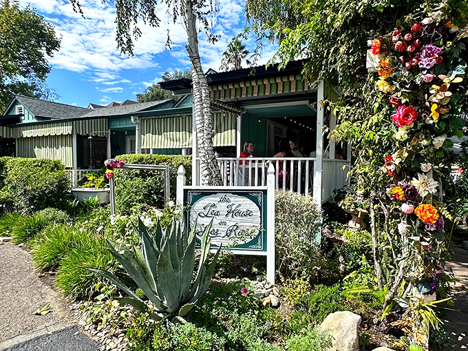 A cottage straight from a storybook, complete with birch trees, blooming flowers, and a porch that practically begs you to sit and stay awhile.