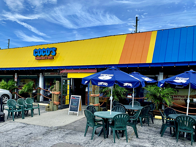The vibrant yellow and blue exterior of Coco's Crush Bar screams "Florida fun" louder than a retiree who just hit the jackpot at bingo night.