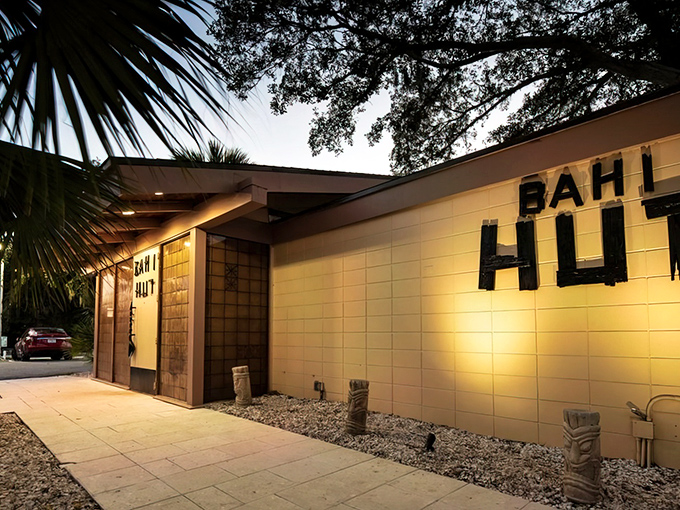 Modern tiki architecture meets tropical paradise in this stunning Sarasota exterior that beckons like a neon lighthouse.