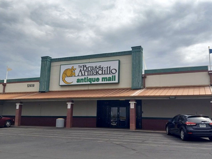 The teal-trimmed facade of Brass Armadillo beckons like a siren song to vintage lovers. This unassuming exterior hides a treasure trove within.