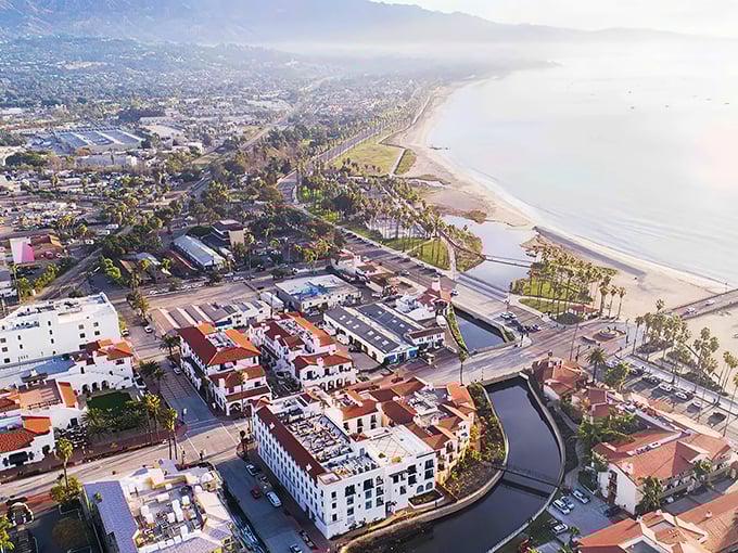 Port Hueneme's aerial view reveals what developers dream about at night&mdash;pristine beaches, Spanish-style architecture, and that perfect California coastline stretching into misty mountains.
