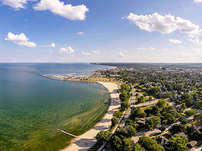 Sheboygan's shoreline stretches like nature's welcome mat, where Lake Michigan whispers, "Come on in, the water's just fine... most of the year!"