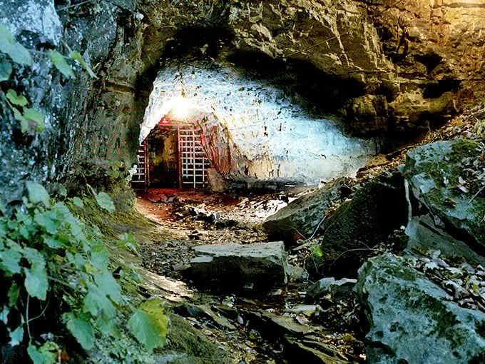 The entrance beckons with an eerie iron gate, like nature's own haunted doorway into Tennessee's most infamous supernatural hotspot.