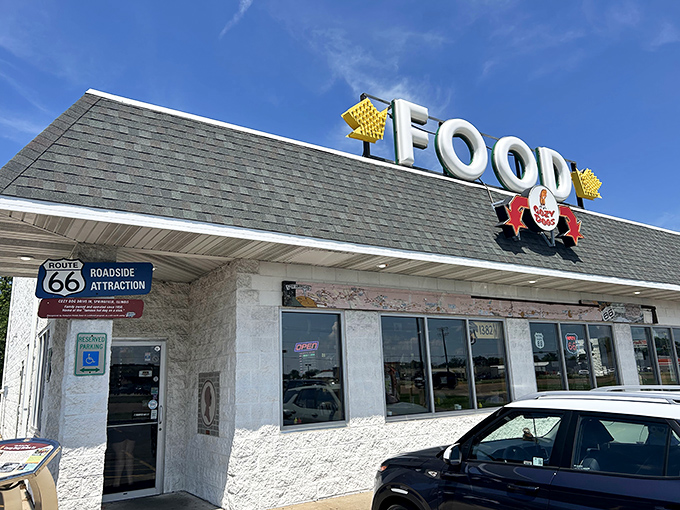 The iconic Cozy Dog Drive In exterior stands proudly along Route 66, its vintage signage beckoning hungry travelers like a deep-fried lighthouse on the prairie.