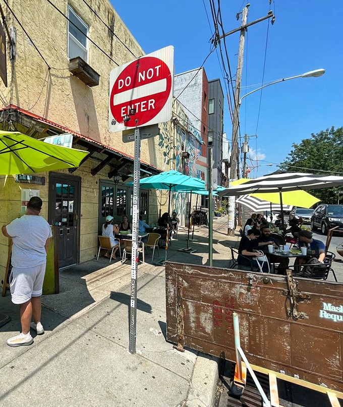 The sidewalk seating at Honey's beckons like an urban oasis, where colorful umbrellas and the promise of comfort food create Philadelphia's perfect breakfast backdrop.