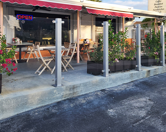 The red awning beckons like a Parisian postcard, promising culinary treasures behind those doors. Florida sunshine meets French charm at this unassuming strip mall gem.