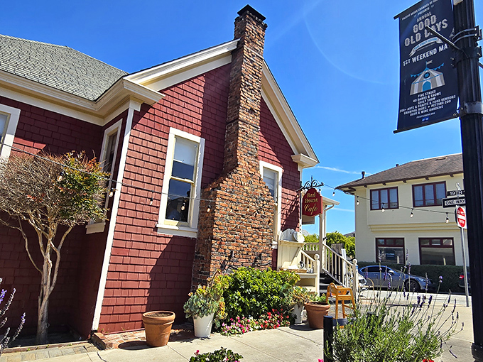 The crimson cottage beckons like a storybook invitation, its white trim and welcoming porch promising comfort before you've even stepped inside.