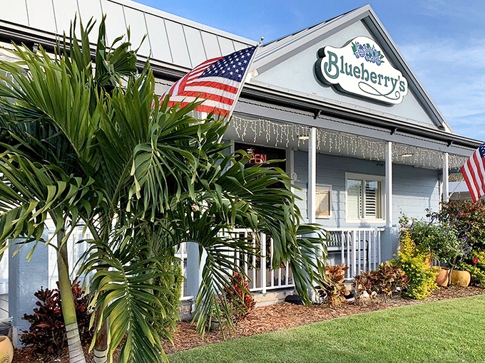 Blueberry's charming cottage exterior says "slow down and eat something wonderful" with its welcoming porch and tropical landscaping.