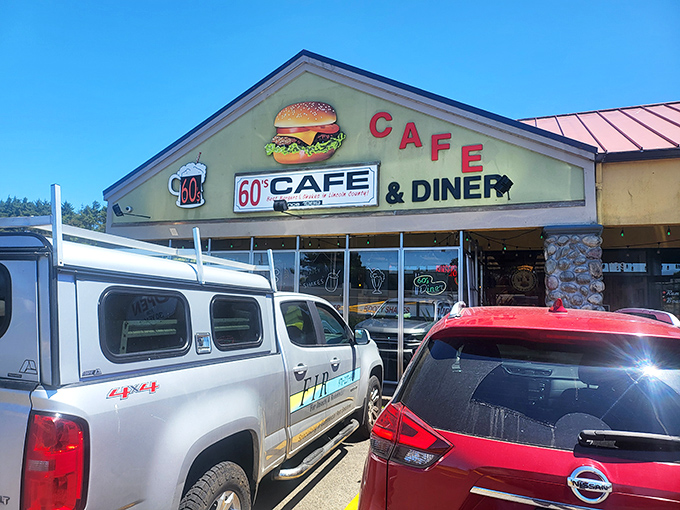The lime green exterior with its giant burger sign isn't subtle—it's a beacon calling to hungry travelers like a retro lighthouse for your appetite.