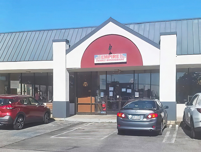 The red-arched entrance of Empire Family Diner stands like a beacon of breakfast hope in Norristown. Morning salvation awaits inside.
