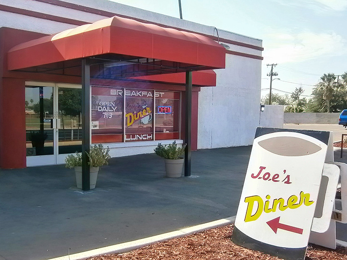 The iconic red awning of Joe's Diner beckons like a beacon of breakfast hope to hungry Phoenix locals seeking their morning salvation.