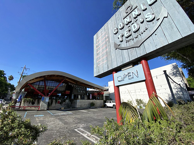 The architectural marvel that is Connie and Ted's stands proudly against the California blue sky, its wave-like roof a nod to the oceanic treasures within.