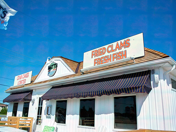 The classic white clapboard exterior of Matt's Fish Camp promises coastal delights with its no-nonsense signage: "FRIED CLAMS, FRESH FISH." Simplicity at its most mouthwatering.