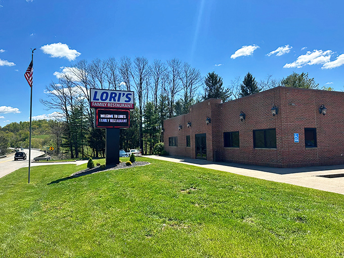 Lori's welcomes visitors with its no-nonsense brick exterior and American flag—proof that culinary treasures often hide in plain sight.