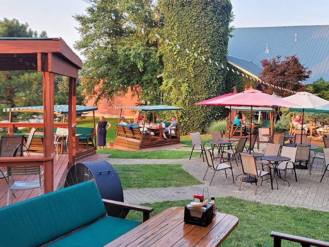 The welcoming facade of The Grill House beckons like an old friend, promising culinary delights behind its cream-colored exterior and flower-adorned entrance.