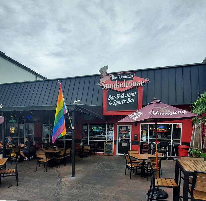 The vibrant red exterior of The Dunedin Smokehouse welcomes hungry visitors with its unpretentious charm. This is where BBQ dreams come true in downtown Dunedin.