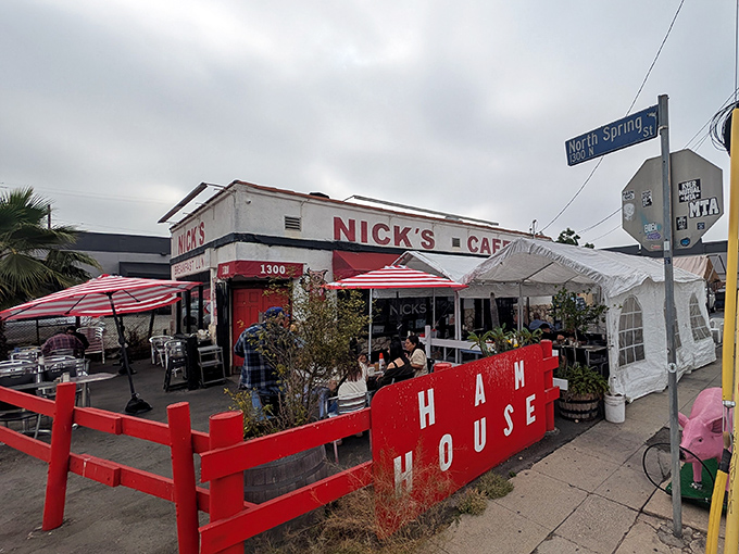 The iconic white building with bold red trim stands like a time capsule on North Spring Street, beckoning hungry Angelenos with its no-nonsense charm.