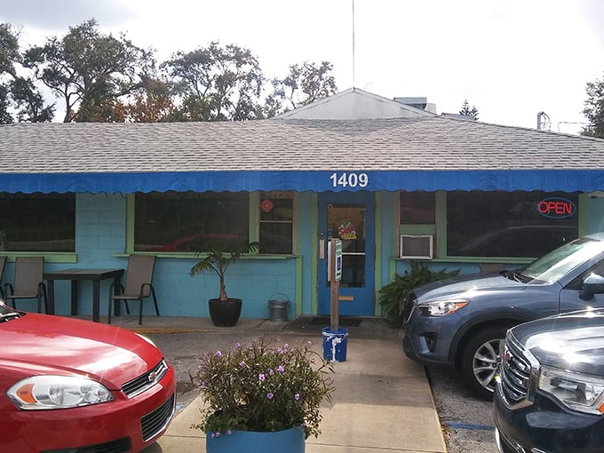 The bright blue exterior of Shep's Diner stands out like a beacon of breakfast hope against the Florida sky, promising culinary comfort inside.