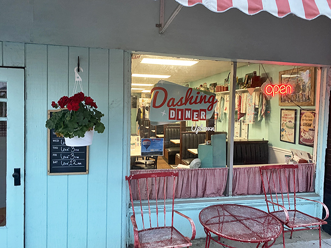 The turquoise facade and red-checkered curtains of Dashing Diner aren't just charming—they're a time portal to when conversation mattered as much as the meal.