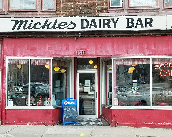 The iconic pink facade of Mickey's Dairy Bar stands as a time capsule on Monroe Street, beckoning hungry Badger fans and locals alike with its vintage charm.