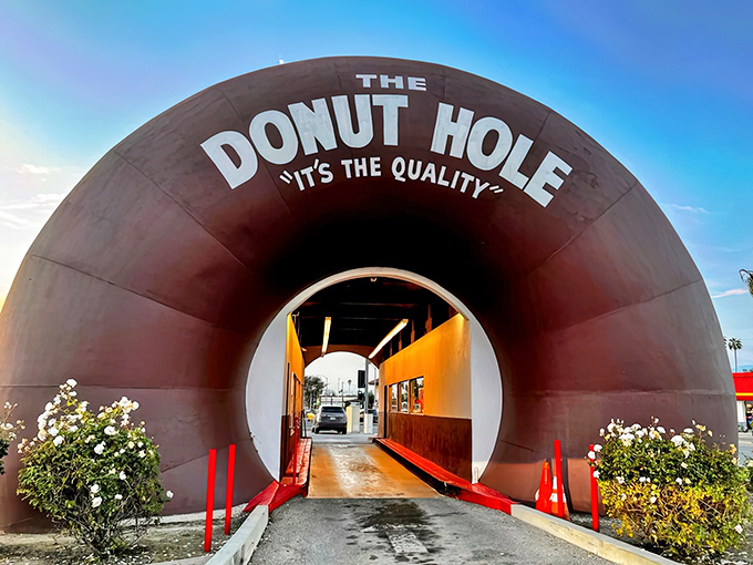 The iconic entrance to The Donut Hole beckons with its giant donut portal—architectural whimsy that promises sweet rewards inside.