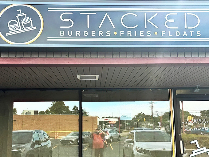 Stacked's bold blue signage promises a straightforward trinity of American comfort food classics: burgers, fries, and those glorious old-fashioned floats. 