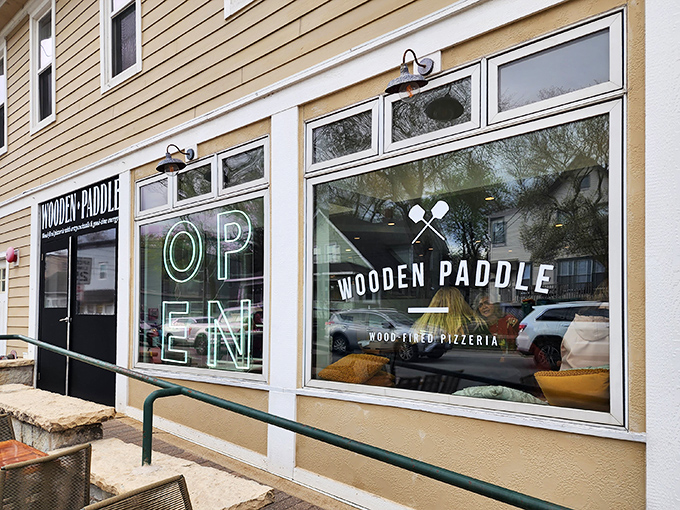 The unassuming yellow exterior of Wooden Paddle in Lemont hides a culinary wonderland within. Pizza paradise doesn't always wear a fancy dress.