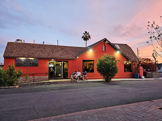 The coral-red exterior of Casa Corazón stands out like a delicious beacon in Phoenix, promising authentic flavors before you even step inside.