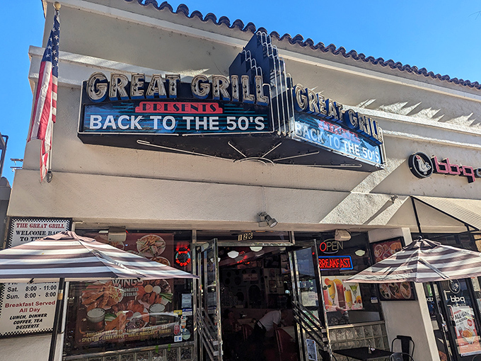 The neon sign beckons like a time portal, American flags standing guard at this Burbank treasure where nostalgia is always on the menu.