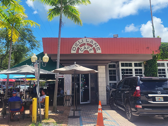 The iconic red roof of Deli Lane Cafe welcomes you like an old friend, with swaying palms providing that quintessential South Florida greeting.