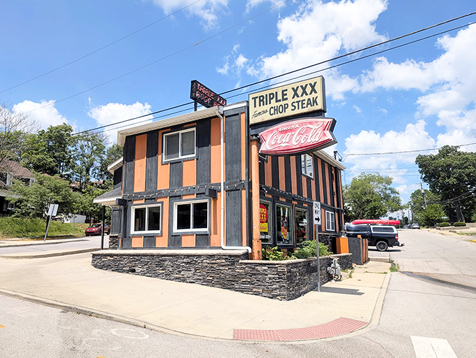 The iconic orange and black striped exterior of Triple XXX stands like a Halloween party that never ended, beckoning hungry travelers with nostalgic charm.