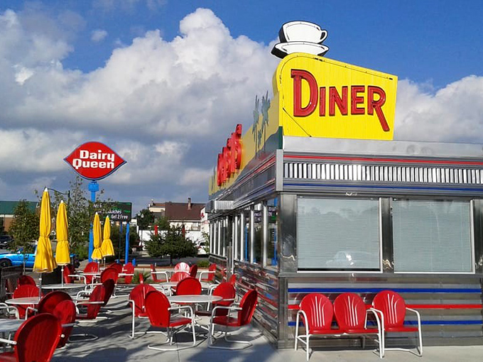 The sunshine-yellow facade of Oasis Diner beckons like a time machine disguised as a roadside attraction. Those palm trees on the sign? Pure Midwestern optimism.