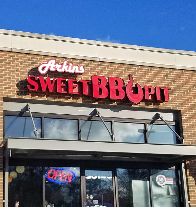 The bright red signage of Arkins Sweet BBQ Pit stands out like a beacon for hungry souls. Michigan's barbecue scene has a not-so-secret hero hiding in plain sight.