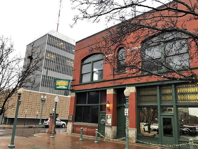 The historic brick fa&ccedil;ade of Bender's Tavern stands proudly in downtown Canton, where American flags flutter like culinary battle standards over the inviting outdoor seating area.